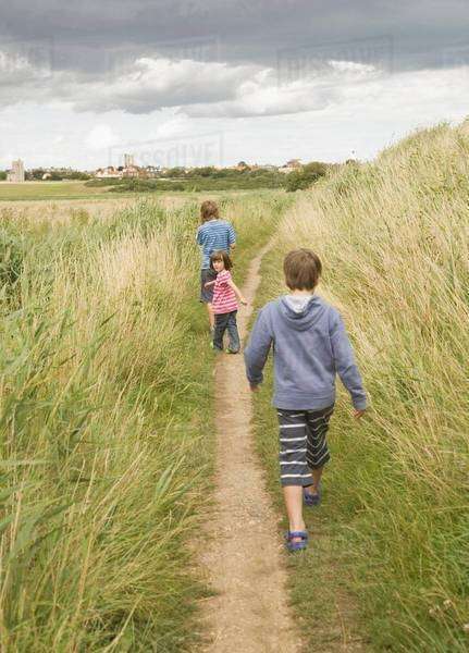Children walking down path - Stock Photo - Dissolve