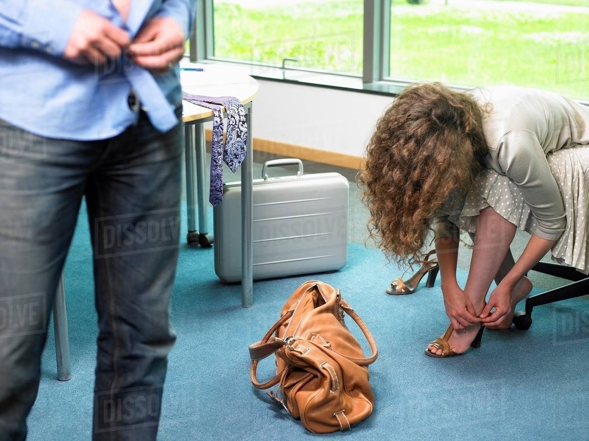 Couple at work, getting dressed again - Stock Photo - Dissolve