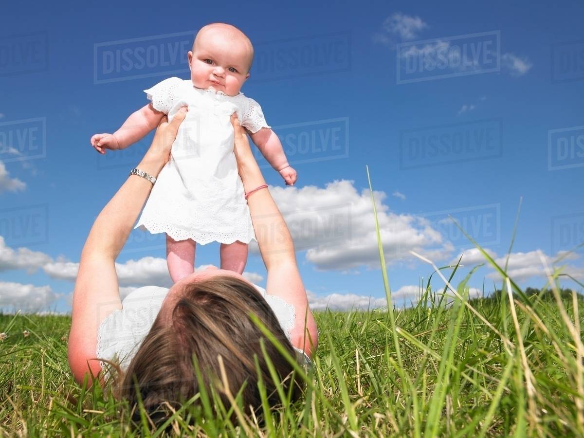 Mother and baby in field - Stock Photo - Dissolve