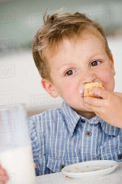 Young boy eating sweet dumpling - Royalty-free Stock Photo | Dissolve