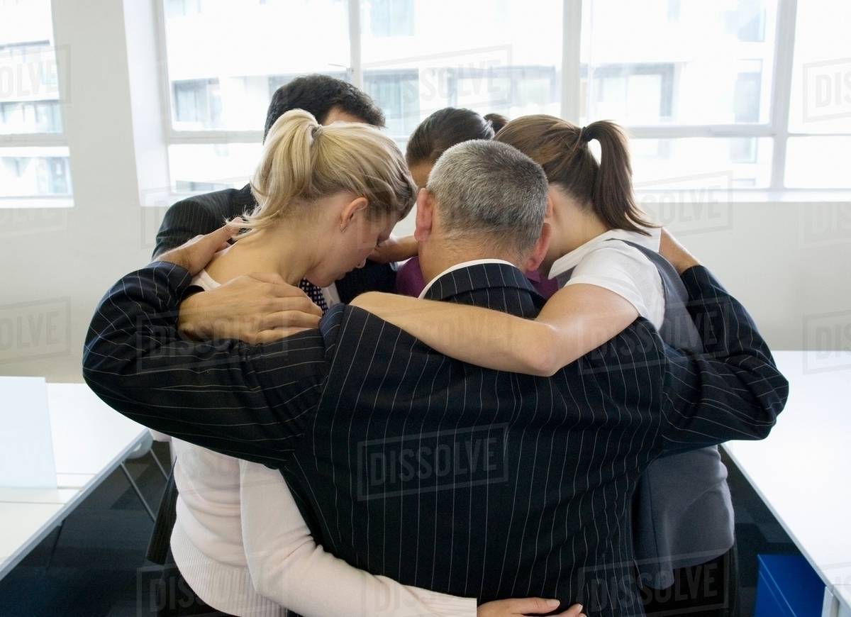 A portrait of a business team huddling - Royalty-free Stock Photo ...