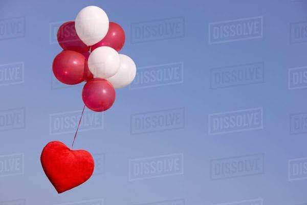 Heart flying with helium balloons - Royalty-free Stock Photo | Dissolve