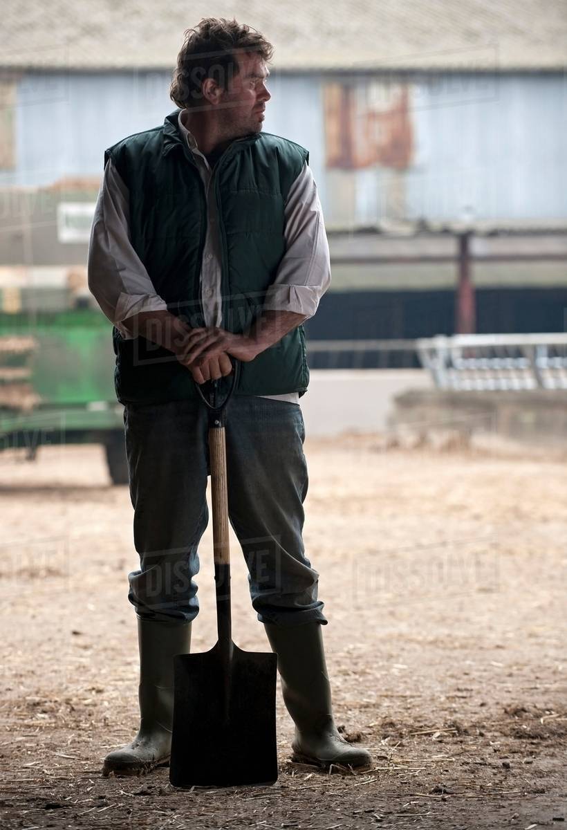 Farmer relaxing with shovel - Royalty-free Stock Photo | Dissolve