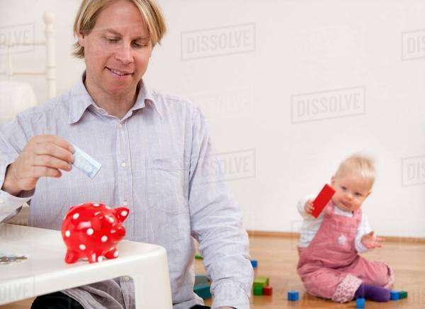 Father saving for baby - Royalty-free Stock Photo | Dissolve