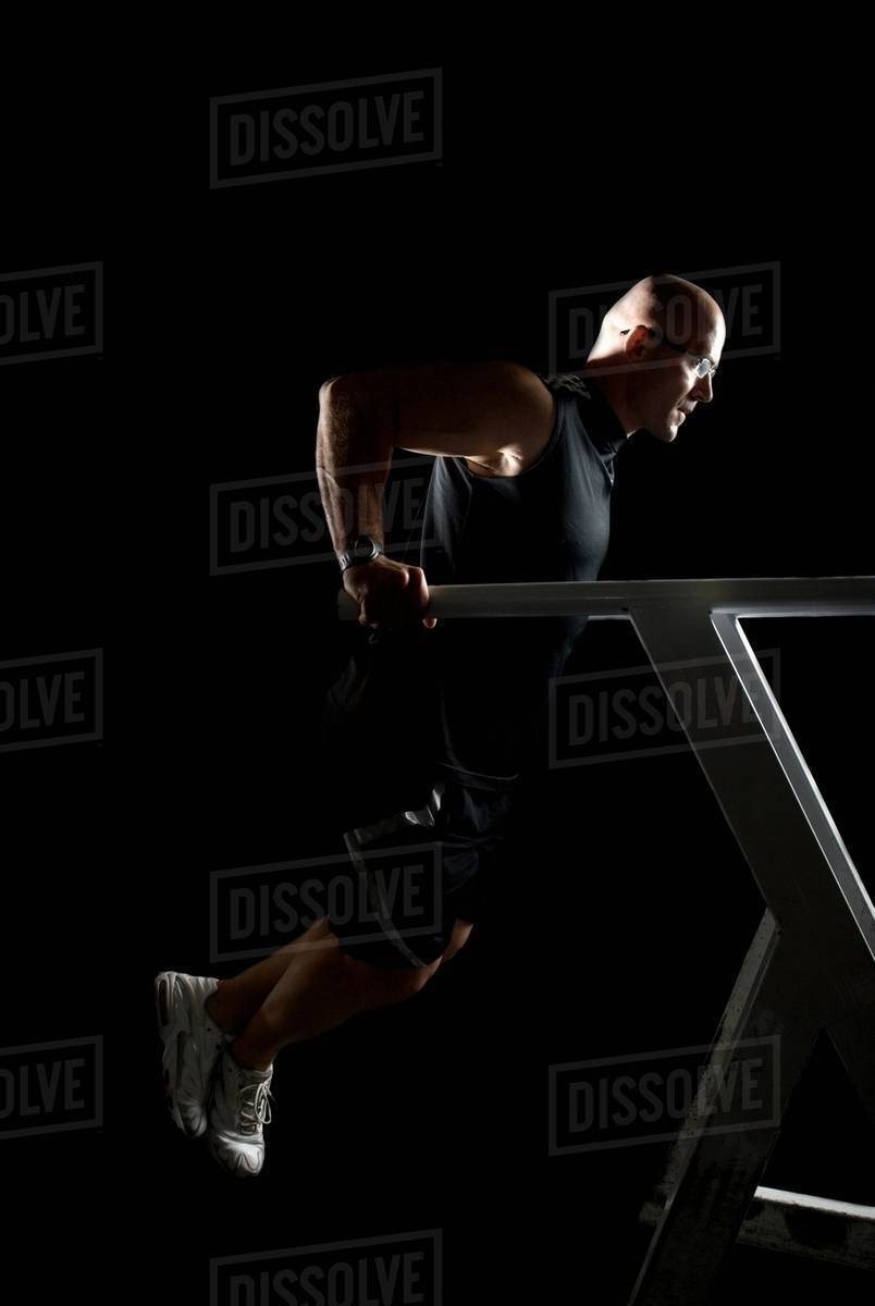Bodybuilder doing triceps dips - Stock Photo - Dissolve