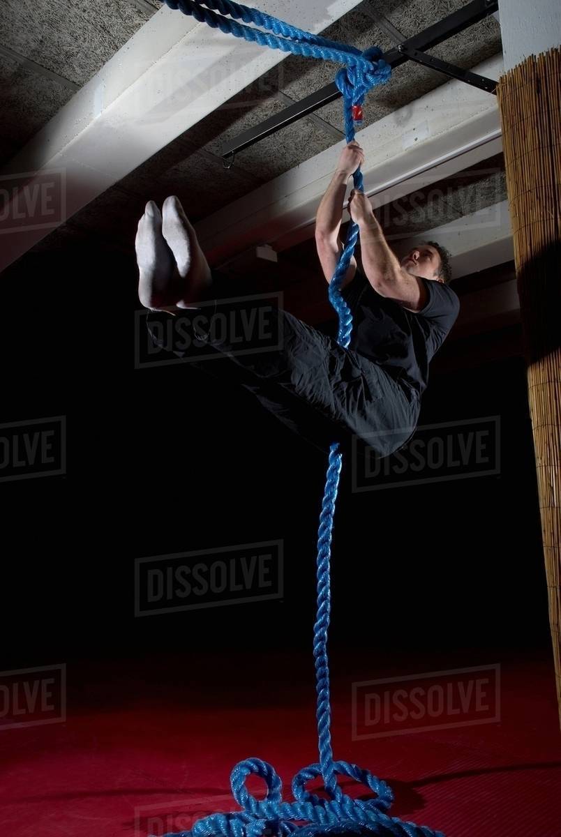 Man doing rope exercises - Royalty-free Stock Photo | Dissolve