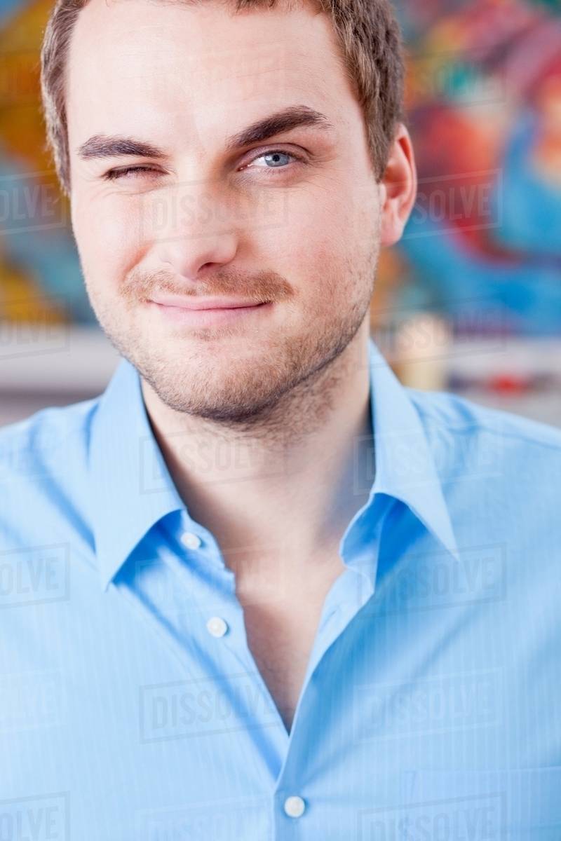 Man winking with one eye - Stock Photo - Dissolve