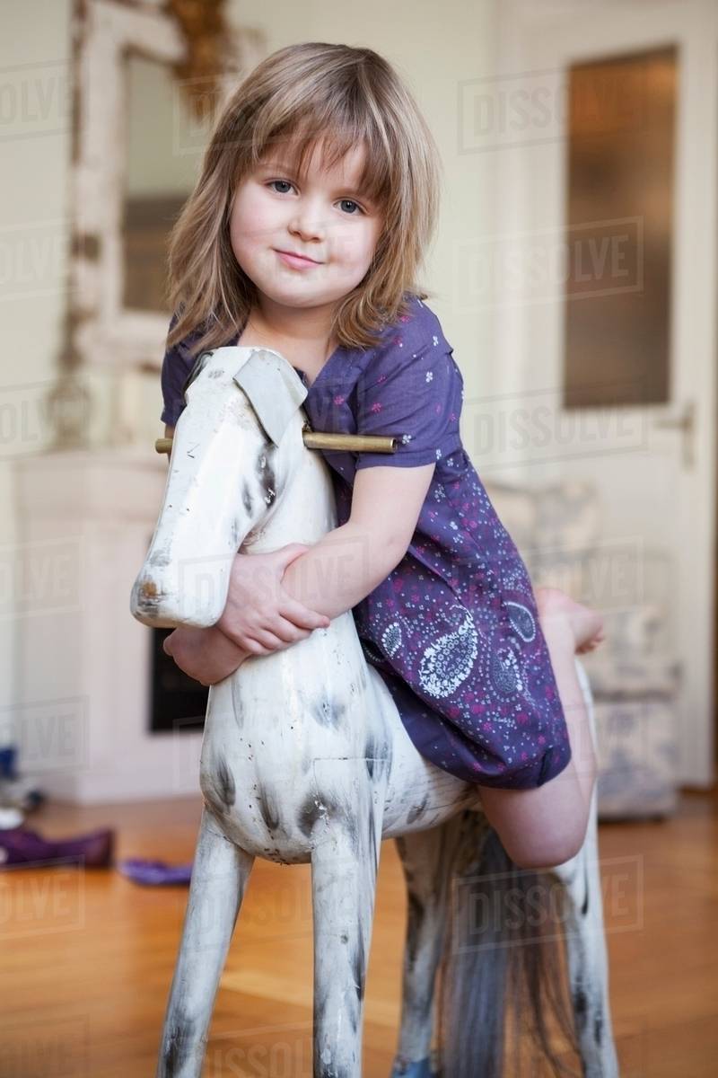 Little girl riding rocking horse - Royalty-free Stock Photo | Dissolve
