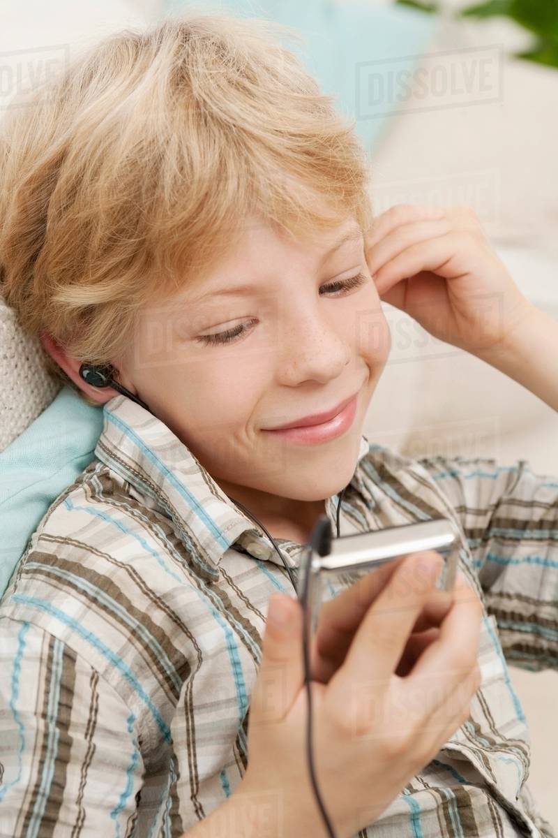 A boy listening to an MP3 player - Royalty-free Stock Photo | Dissolve