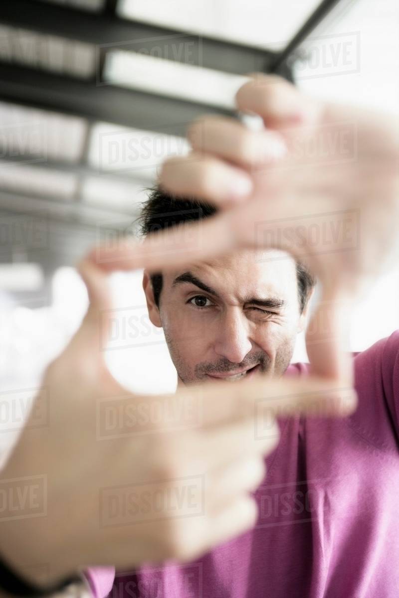 Man Looking through Finger - Stock Photo - Dissolve