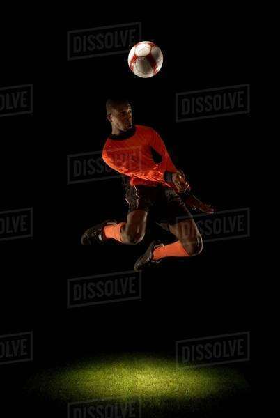 Footballer jumping for header - Royalty-free Stock Photo | Dissolve