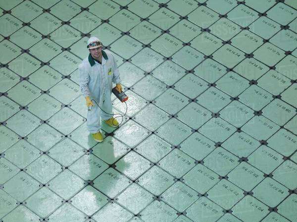 Engineer on Nuclear Reactor Pile cap - Stock Photo - Dissolve