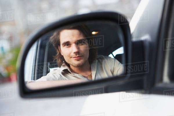 Man looking at driving mirror - Royalty-free Stock Photo | Dissolve