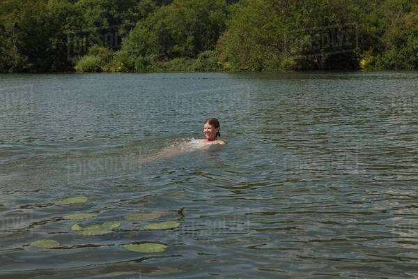 Woman swimming in river - Stock Photo - Dissolve