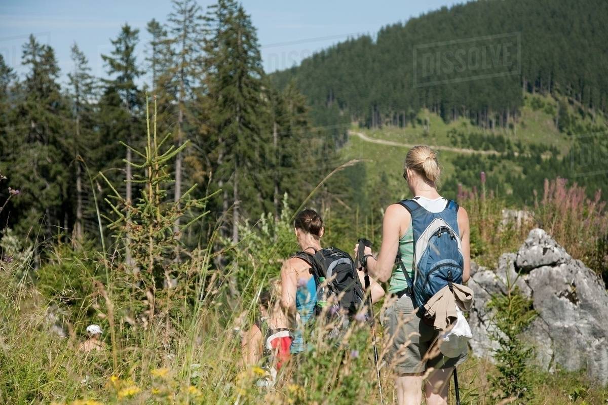 Girls trekking through the mountains - Royalty-free Stock Photo | Dissolve