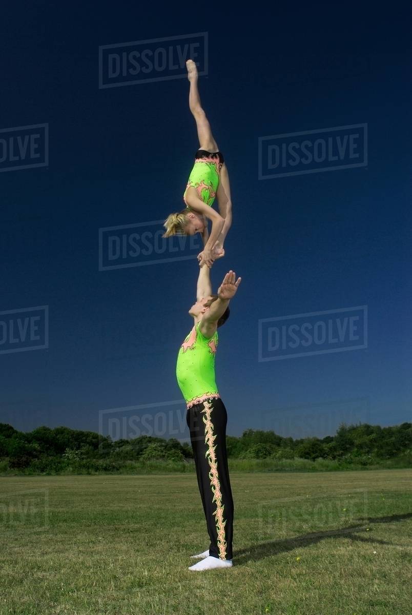 Acrobatic troop performing moves - Royalty-free Stock Photo | Dissolve