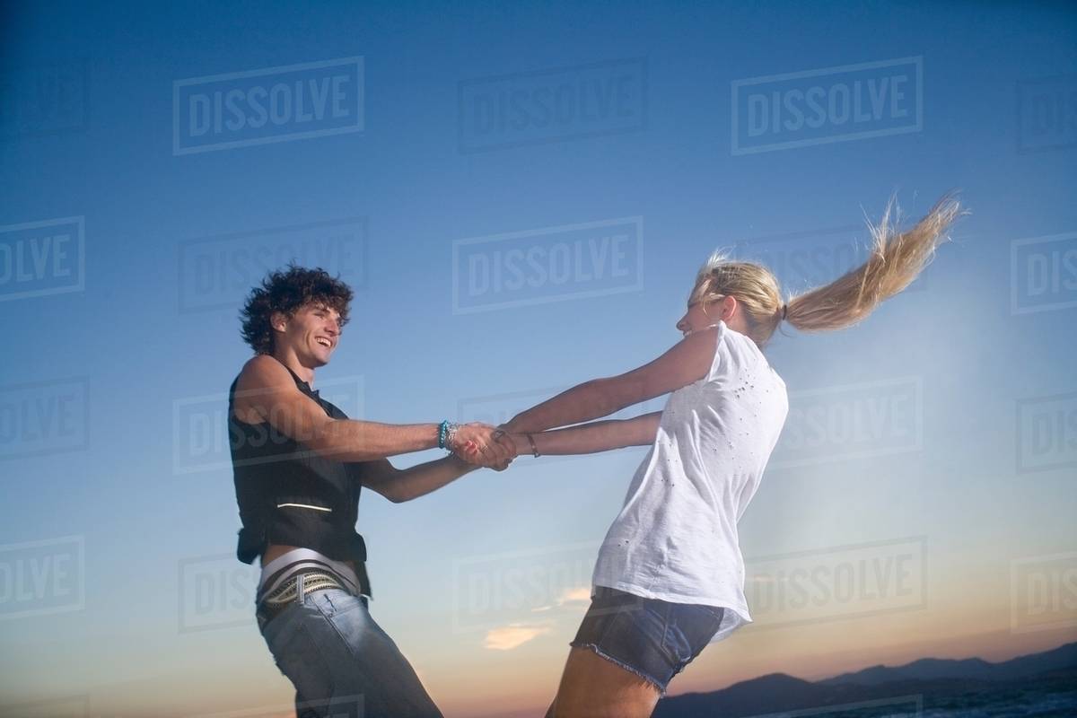 Young cple twirl outside fun - Royalty-free Stock Photo | Dissolve