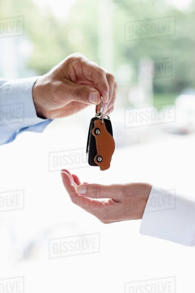 Handing over key - Stock Photo - Dissolve