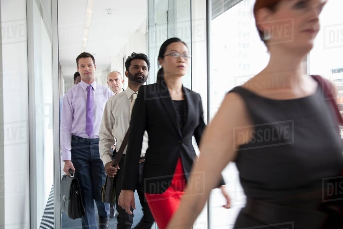 Business people rushing past camera - Royalty-free Stock Photo | Dissolve