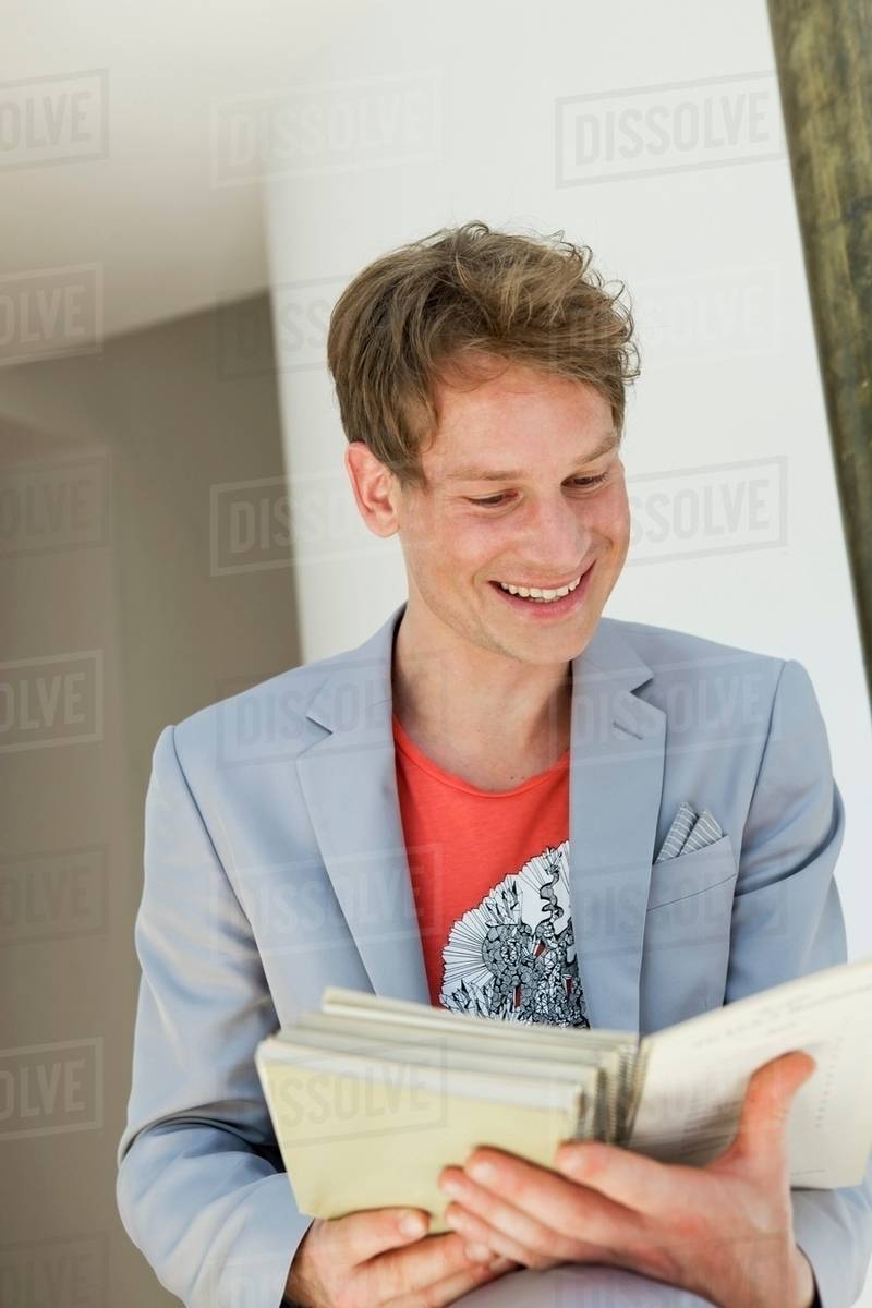 Young man reading - Stock Photo - Dissolve