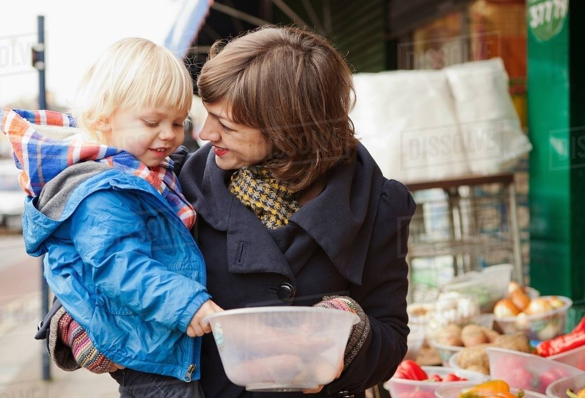 Mother and son shopping at street market stall - Royalty-free Stock ...