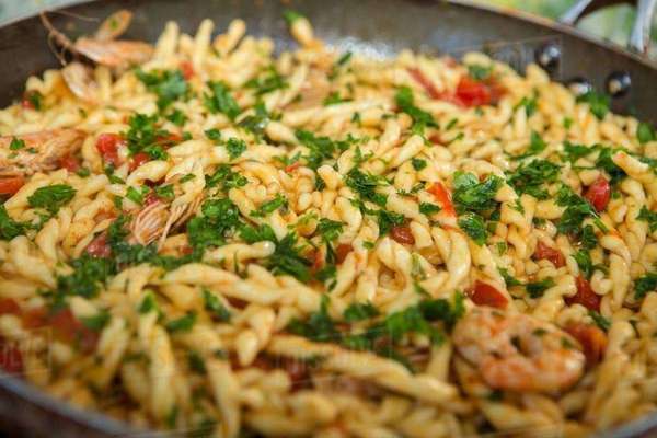 Pan of pasta with tomatoes and prawns - Stock Photo - Dissolve