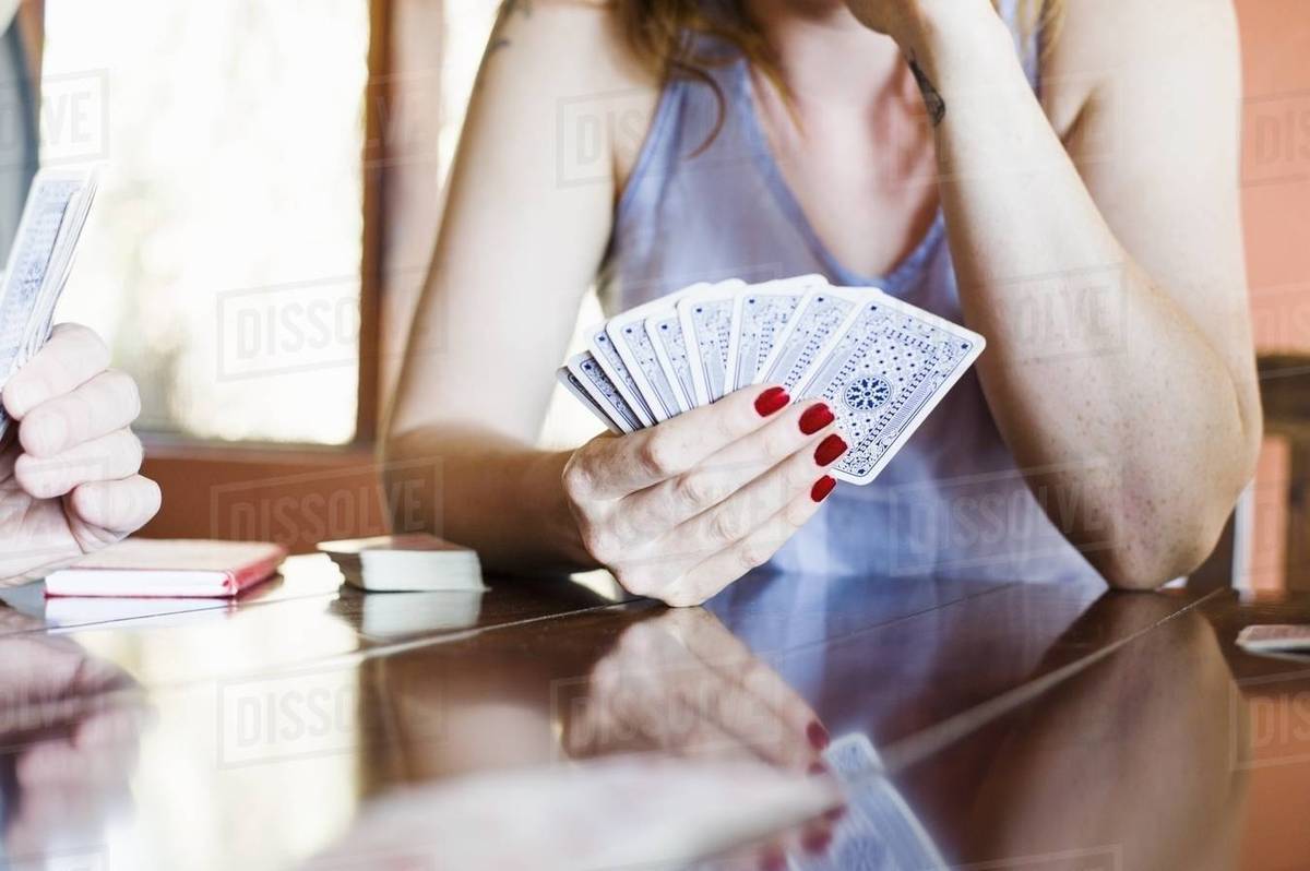 Cropped shot of young woman playing cards - Royalty-free Stock Photo ...