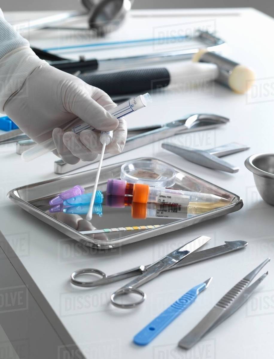 Pathologist taking a DNA sample for analysis during a autopsy - Royalty ...