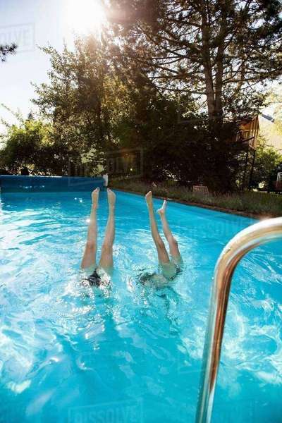 Two teenage girls diving into swimming pool - Royalty-free Stock Photo ...
