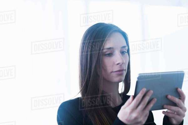 Head and shoulders of young woman using digital tablet - Stock Photo ...