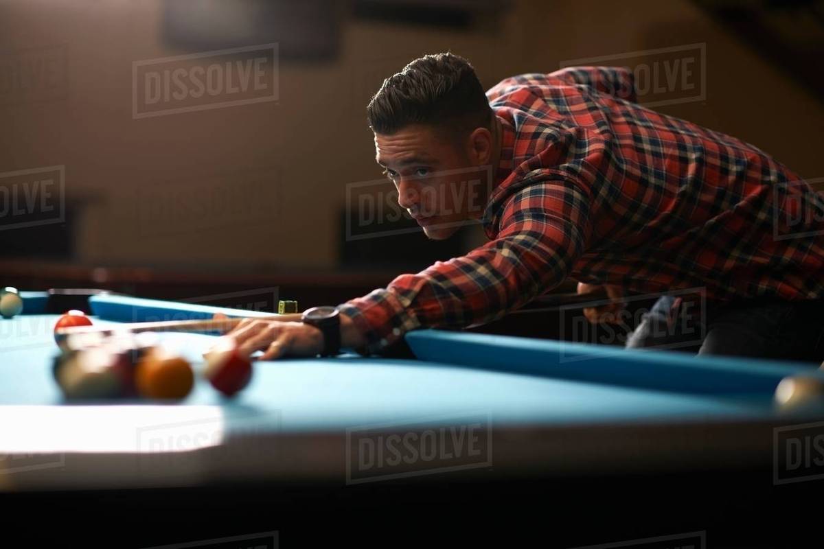 Man playing pool in club - Royalty-free Stock Photo | Dissolve