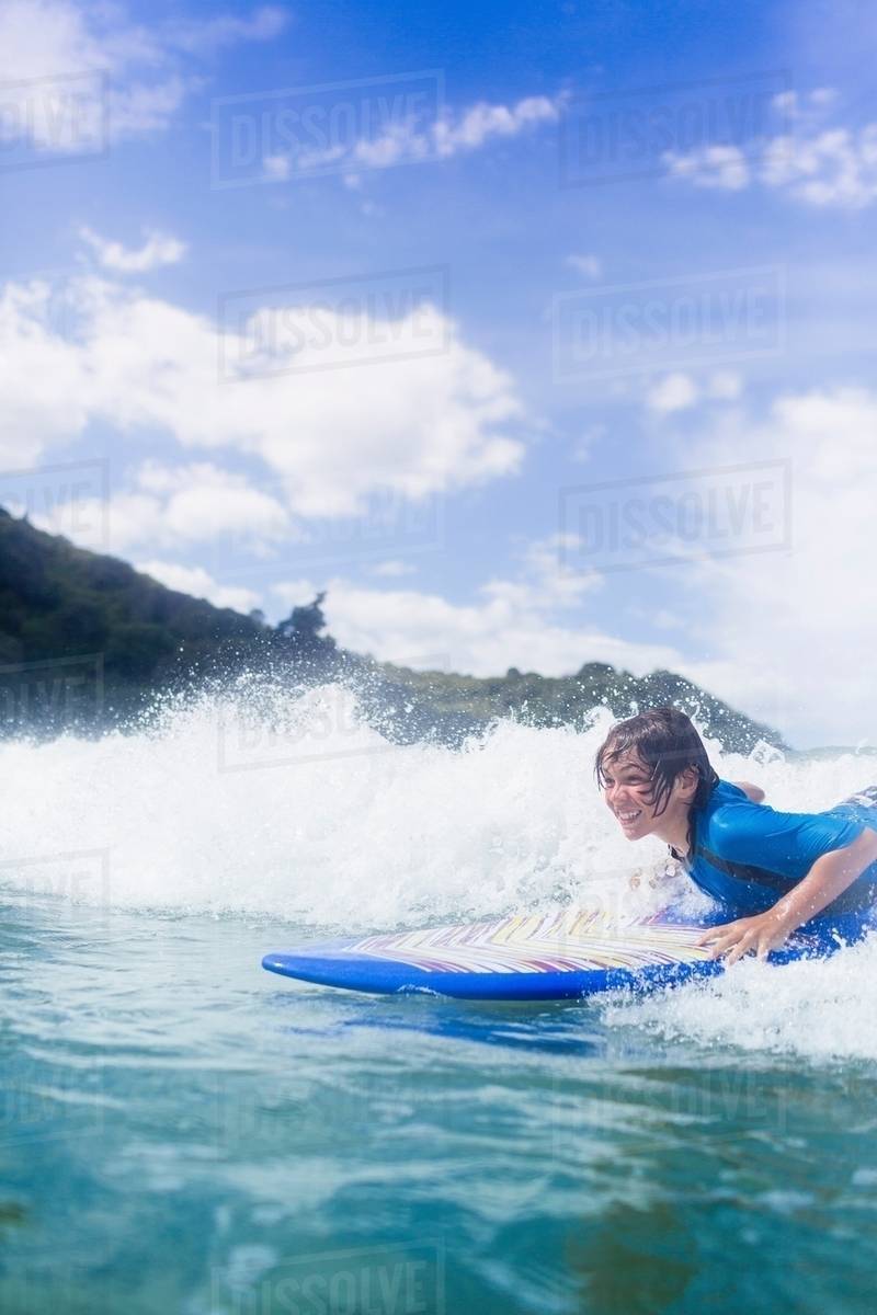 Boy surfer riding the wave - Royalty-free Stock Photo | Dissolve