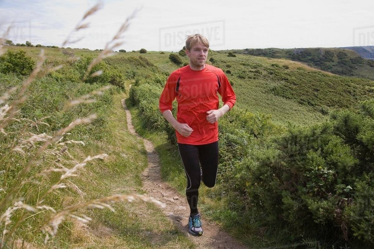 Man running on rural path - Royalty-free Stock Photo | Dissolve
