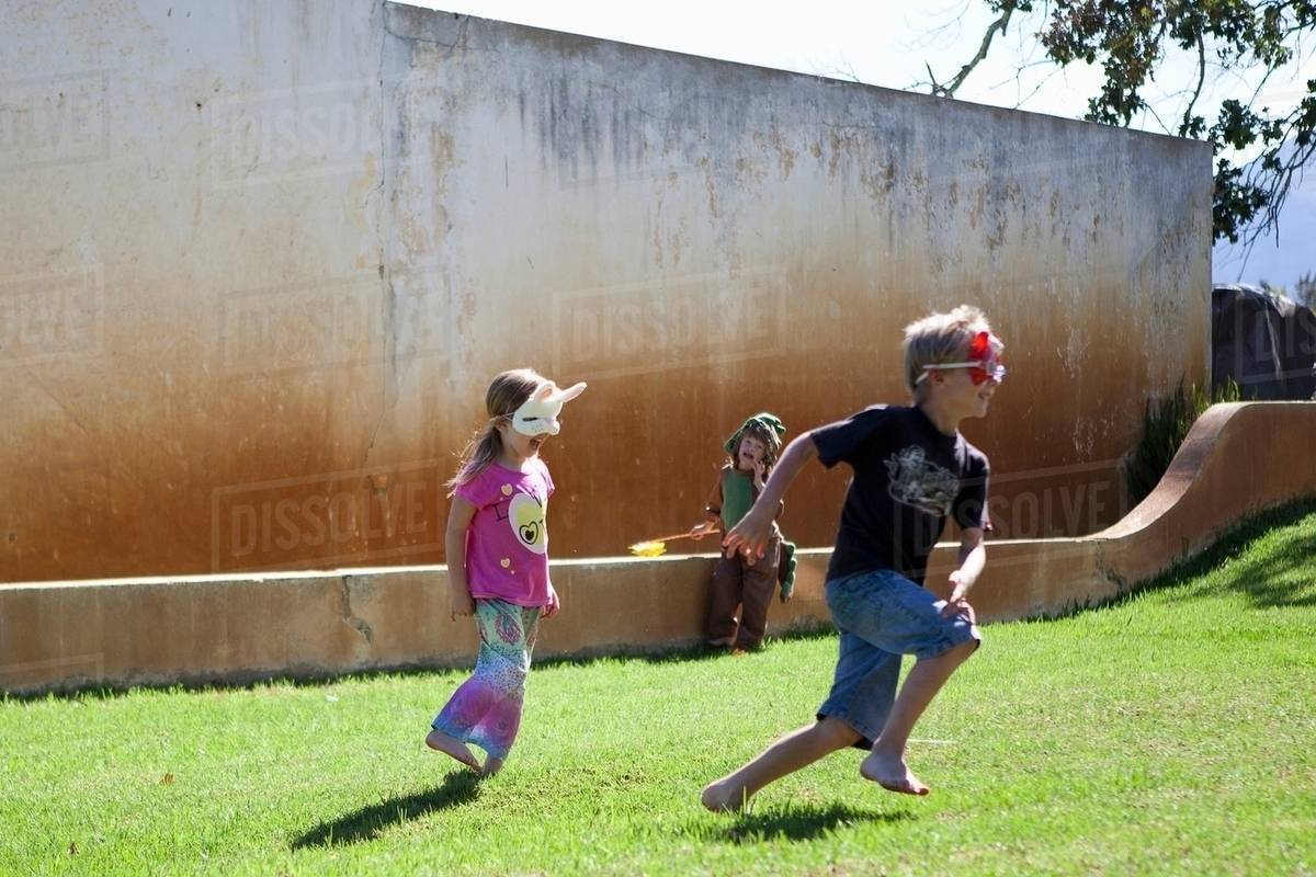Brother and sister playing in backyard - Stock Photo - Dissolve