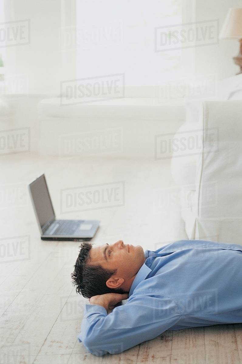 Businessman laying on floor - Stock Photo - Dissolve