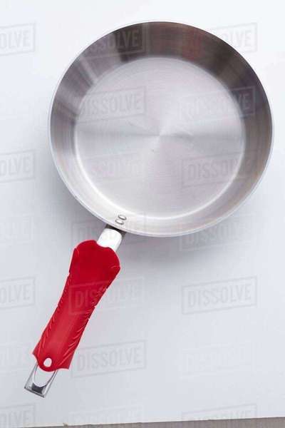 Overhead view of new frying pan with red silicon handle - Stock Photo ...