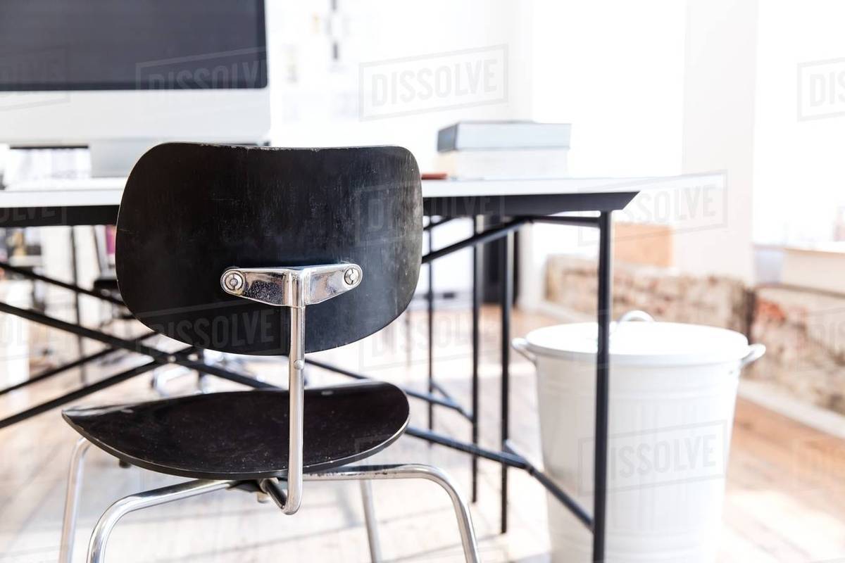 Desk and chairs and rubbish bin in office - Royalty-free Stock Photo ...