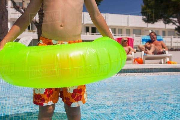 Boy with inflatable at swimming pool - Royalty-free Stock Photo | Dissolve
