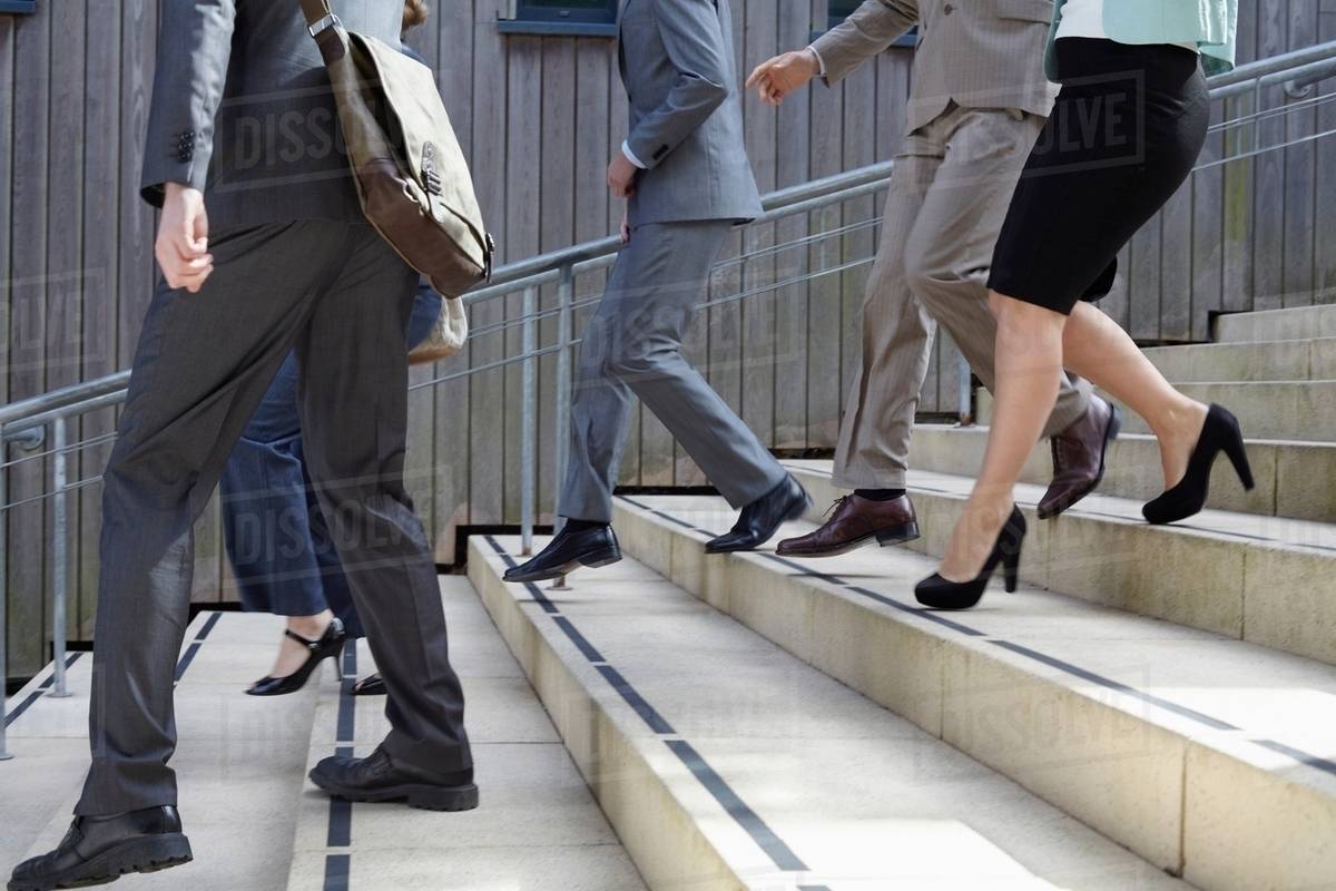 Business people walking down steps - Royalty-free Stock Photo | Dissolve