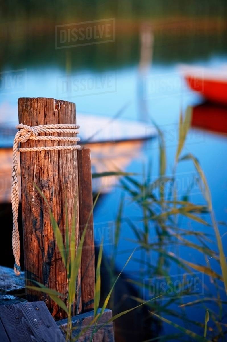 Rope tied on wooden post at dock - Royalty-free Stock Photo | Dissolve
