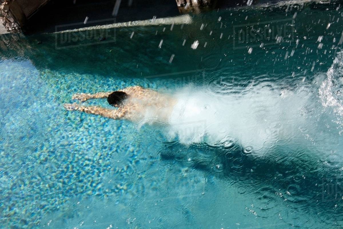 Woman diving into swimming pool - Royalty-free Stock Photo | Dissolve