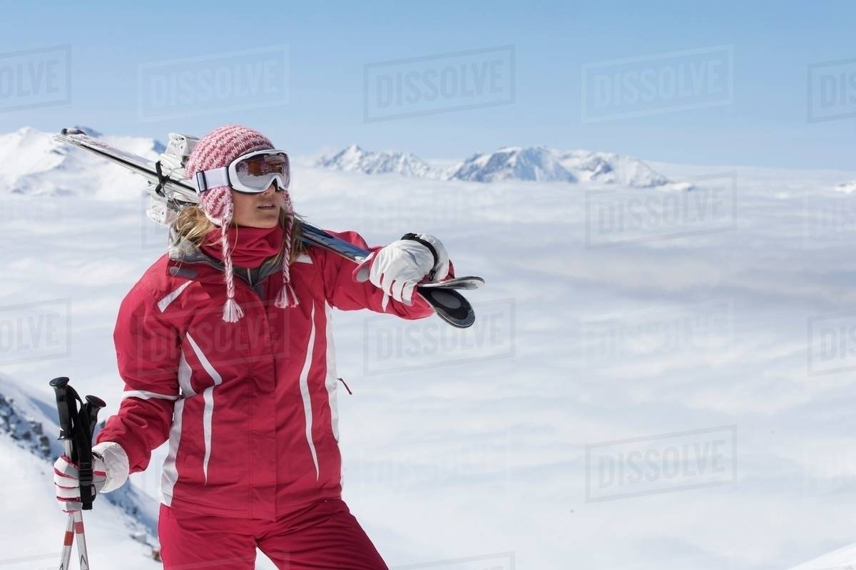 Skier standing on mountainside - Stock Photo - Dissolve