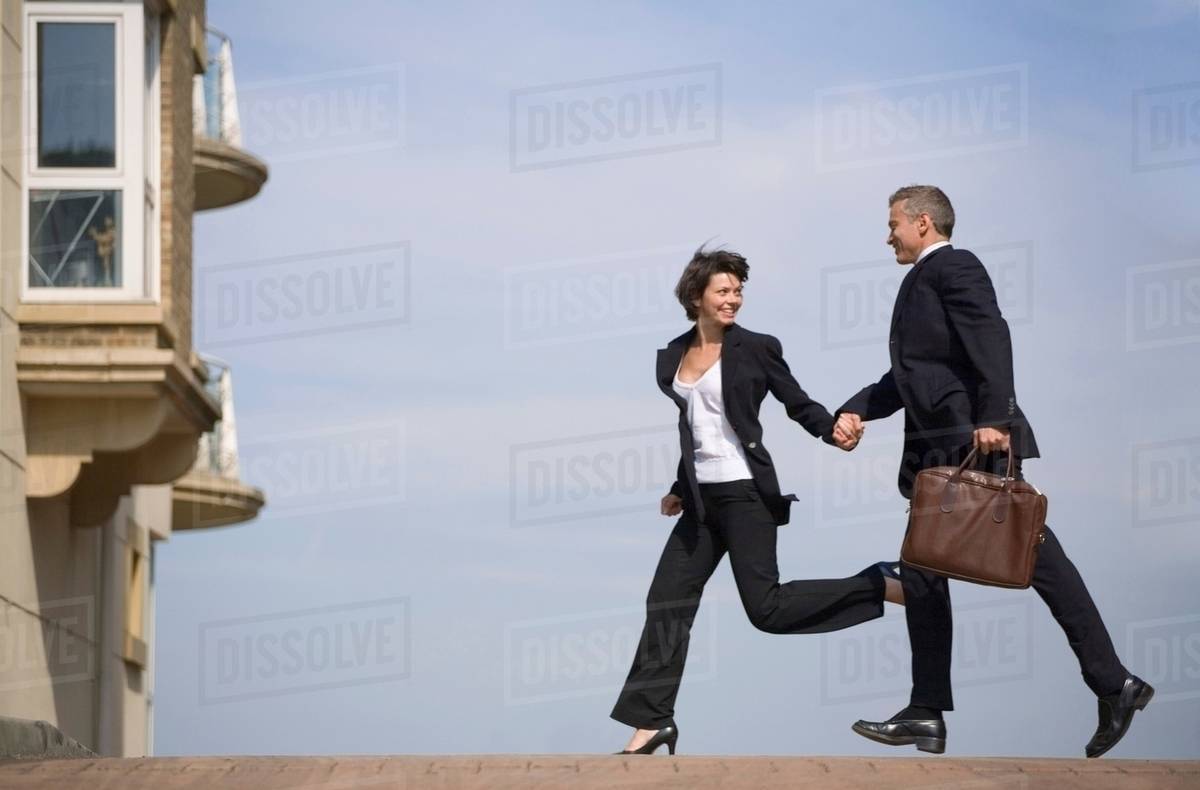 Business people running on street - Stock Photo - Dissolve