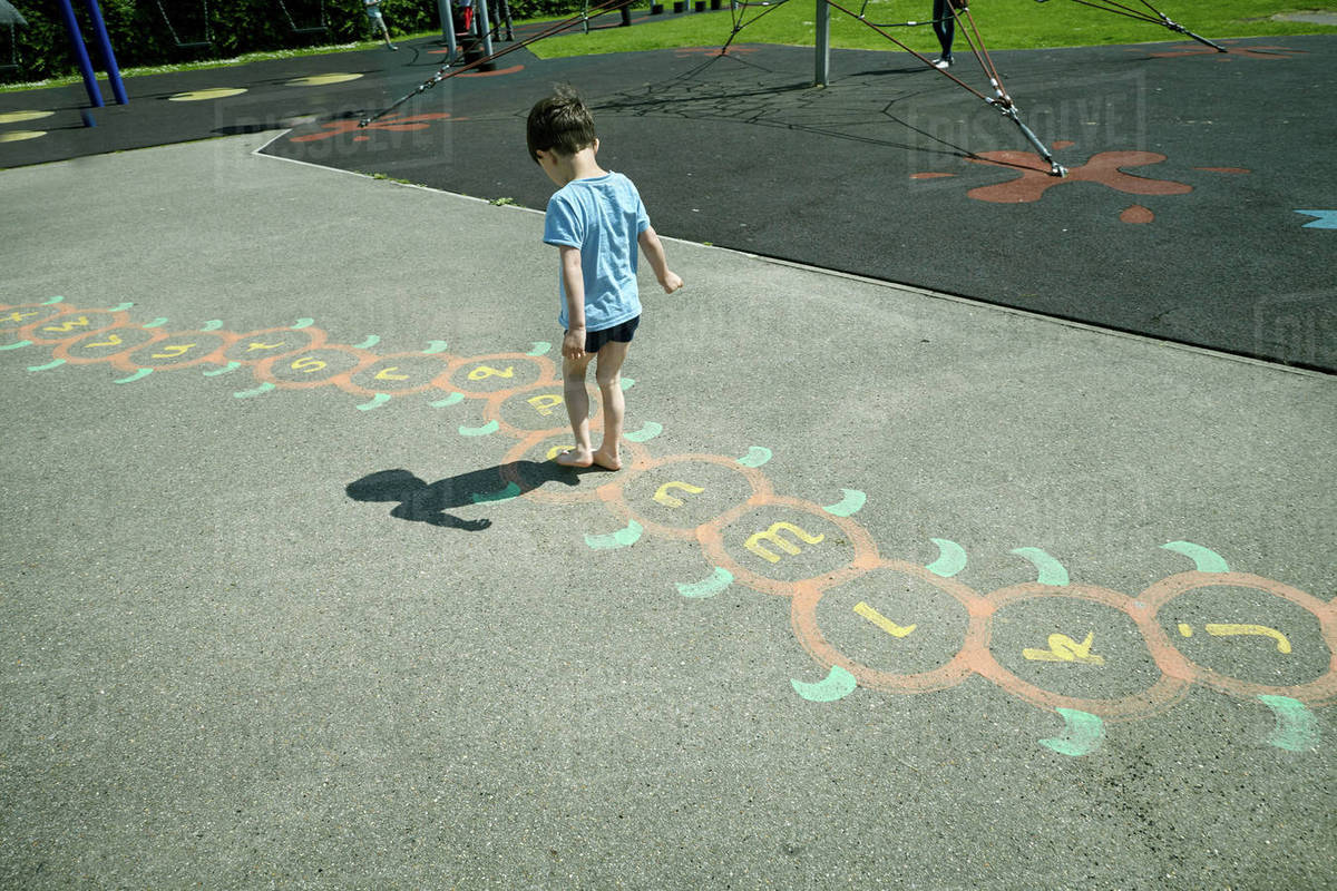 Boy playing hopscotch in playground, Richmond, London - Royalty-free ...
