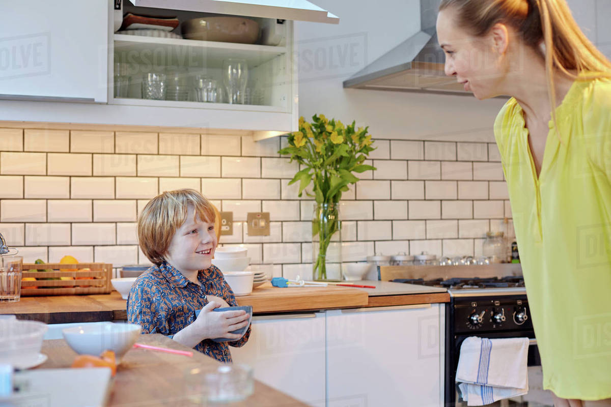 Mother speaking to son in kitchen - Stock Photo - Dissolve