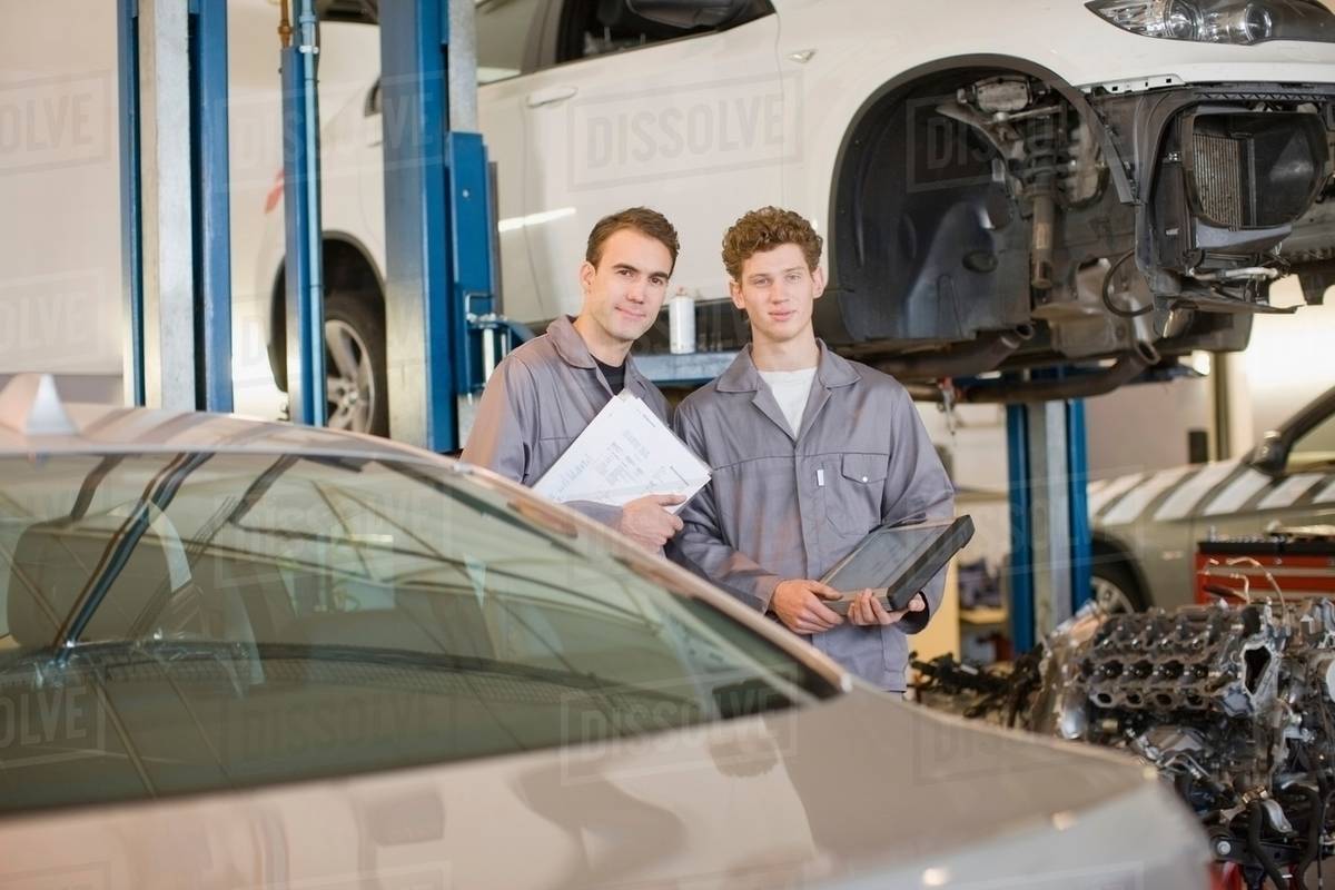 Mechanics working in garage - Royalty-free Stock Photo | Dissolve