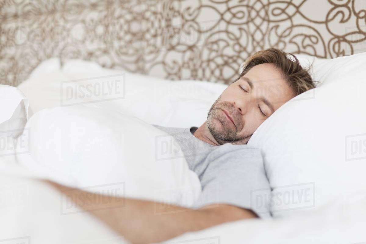 Man asleep in bed - Royalty-free Stock Photo | Dissolve