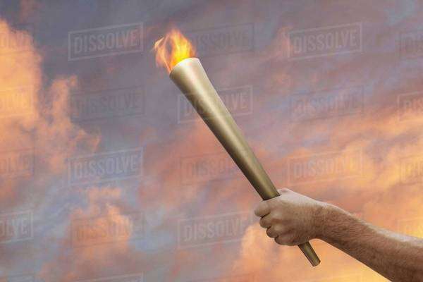 Hand holding flaming baton - Royalty-free Stock Photo | Dissolve