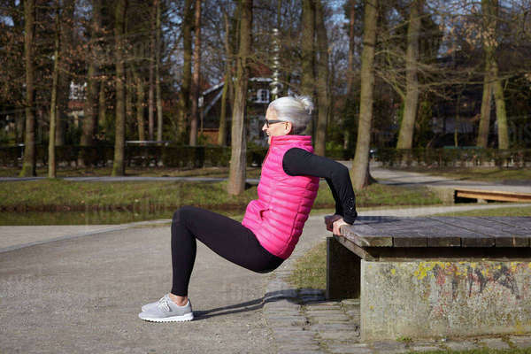 Full length side view of woman doing reverse push up - Stock Photo ...