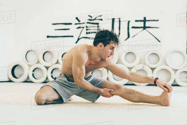 Man touching toes doing leg stretching exercises - Royalty-free Stock ...